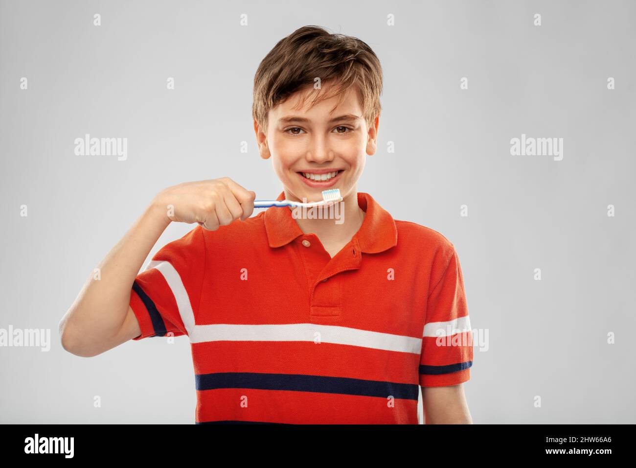 happy boy brushing teeth with toothbrush Stock Photo - Alamy