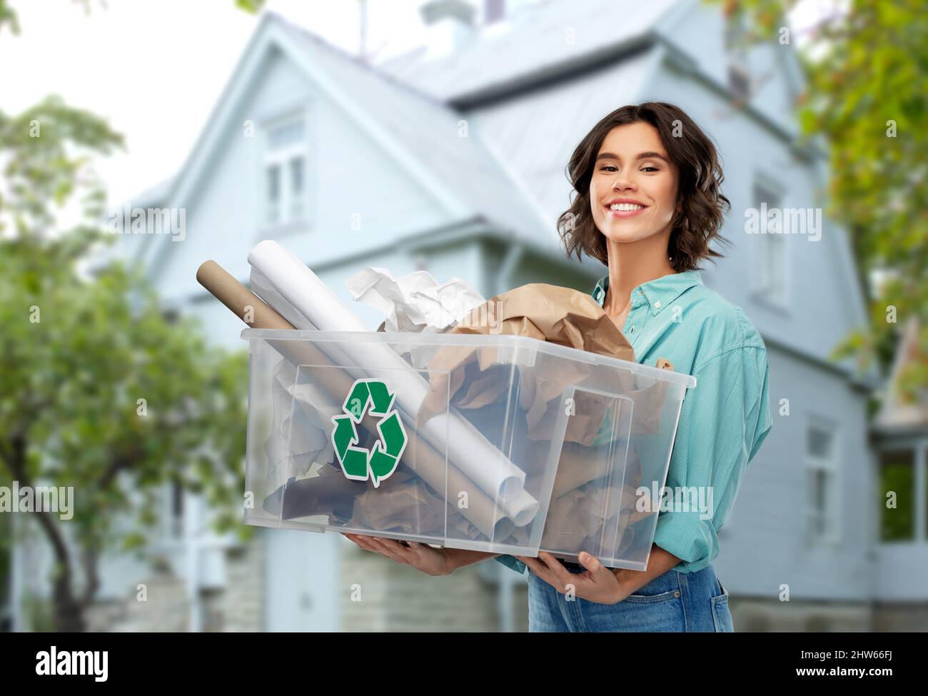 happy smiling young woman sorting paper waste Stock Photo - Alamy