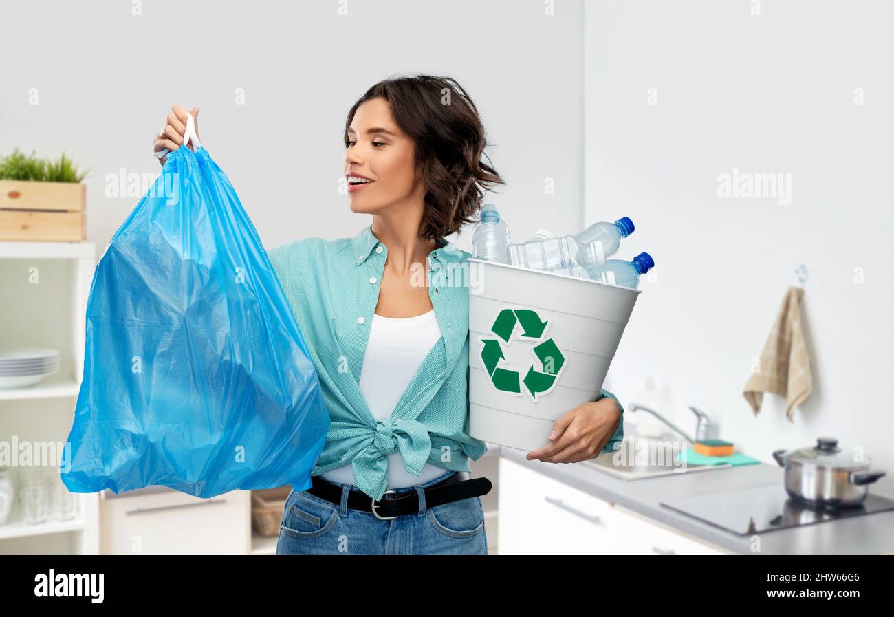 smiling woman sorting plastic waste and trash bag Stock Photo - Alamy