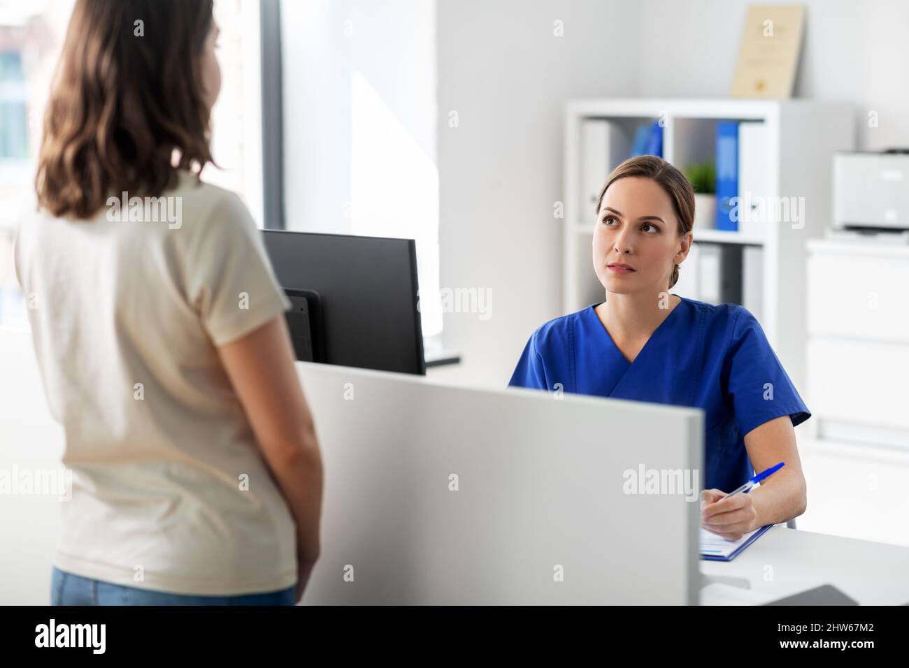 doctor with computer and patient at hospital Stock Photo - Alamy