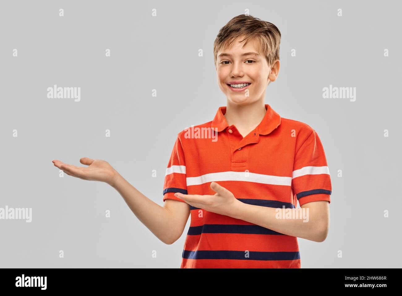 smiling boy showing something invisible Stock Photo - Alamy