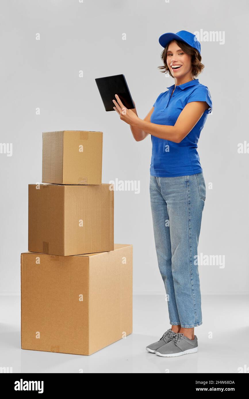 delivery girl with parcel boxes and tablet pc Stock Photo - Alamy