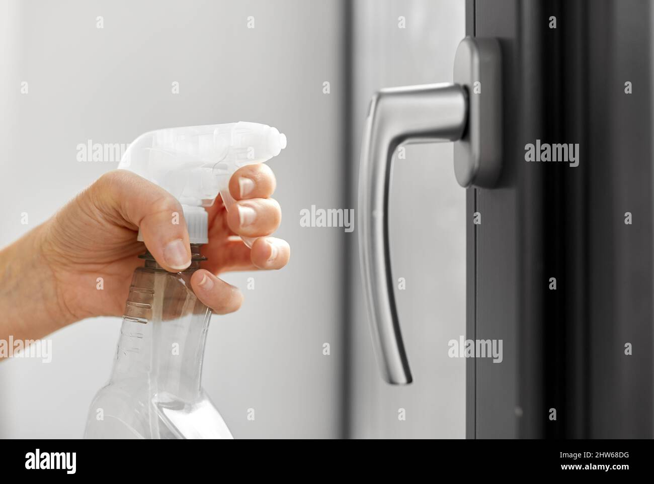 hands cleaning window handle with detergent Stock Photo - Alamy