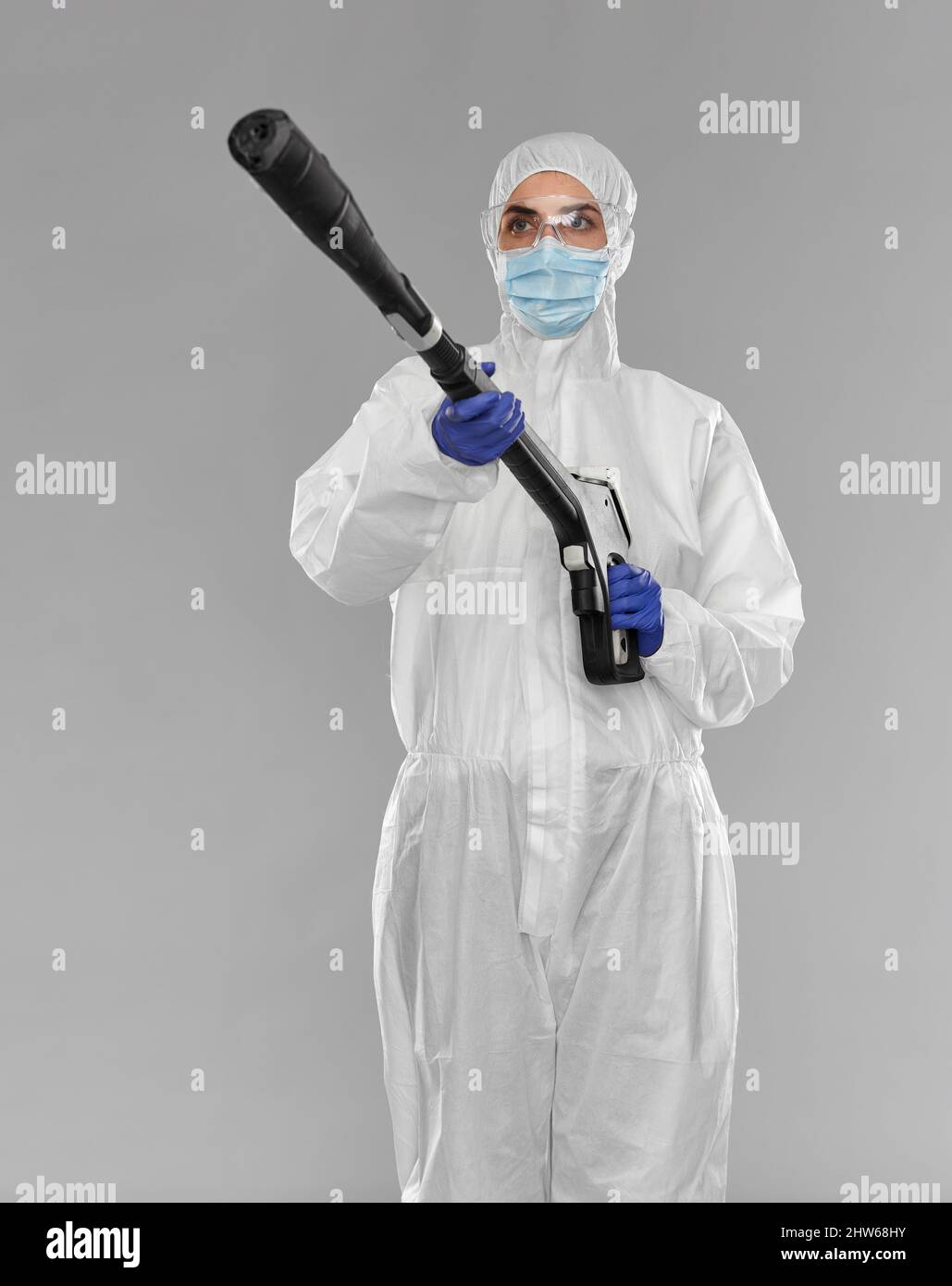 sanitation worker in hazmat with pressure washer Stock Photo - Alamy