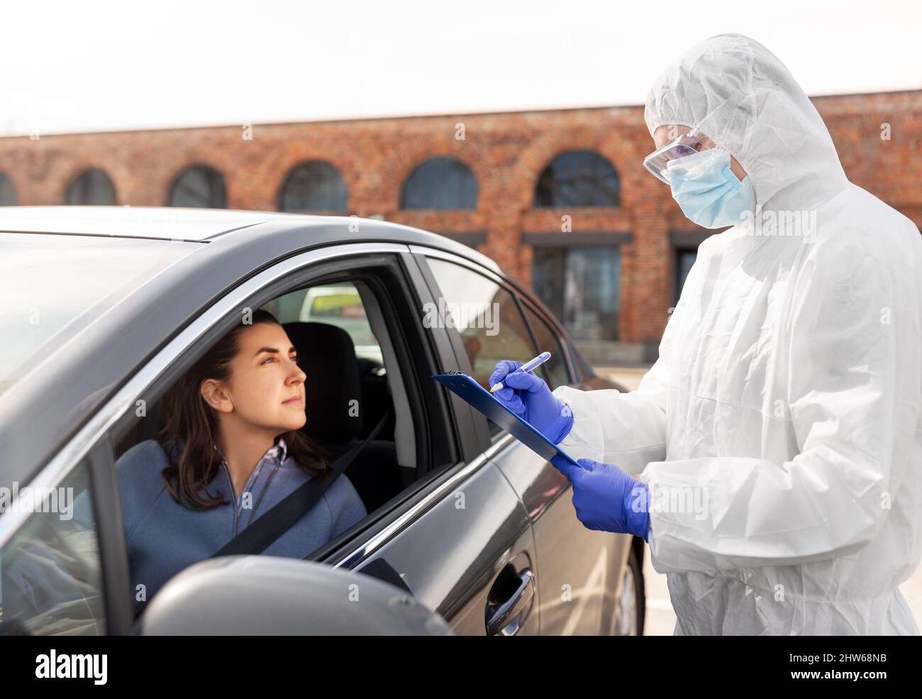 healthcare worker with clipboard and woman in car Stock Photo - Alamy