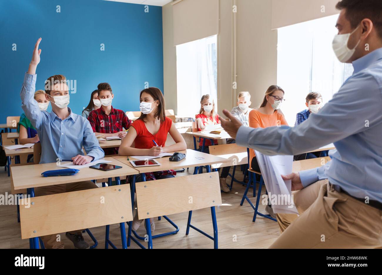 group of students and teacher in masks at school Stock Photo - Alamy