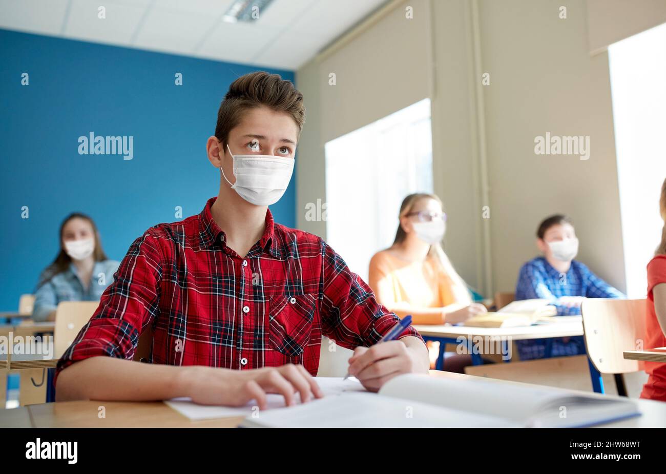 group of students in masks at school lesson Stock Photo - Alamy