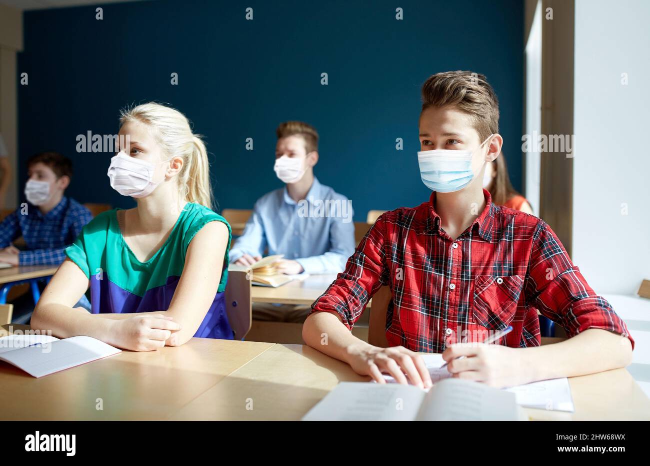 group of students in masks at school lesson Stock Photo - Alamy