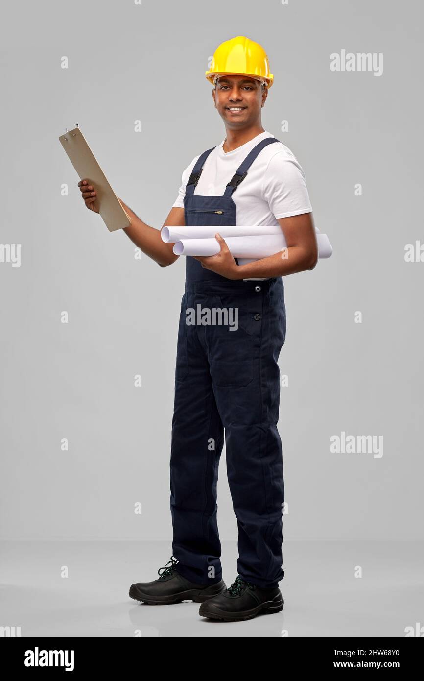happy indian builder with blueprint and clipboard Stock Photo - Alamy