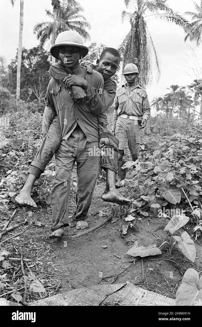 A Biafran soldier seen here carrying an injured comrade during the ...