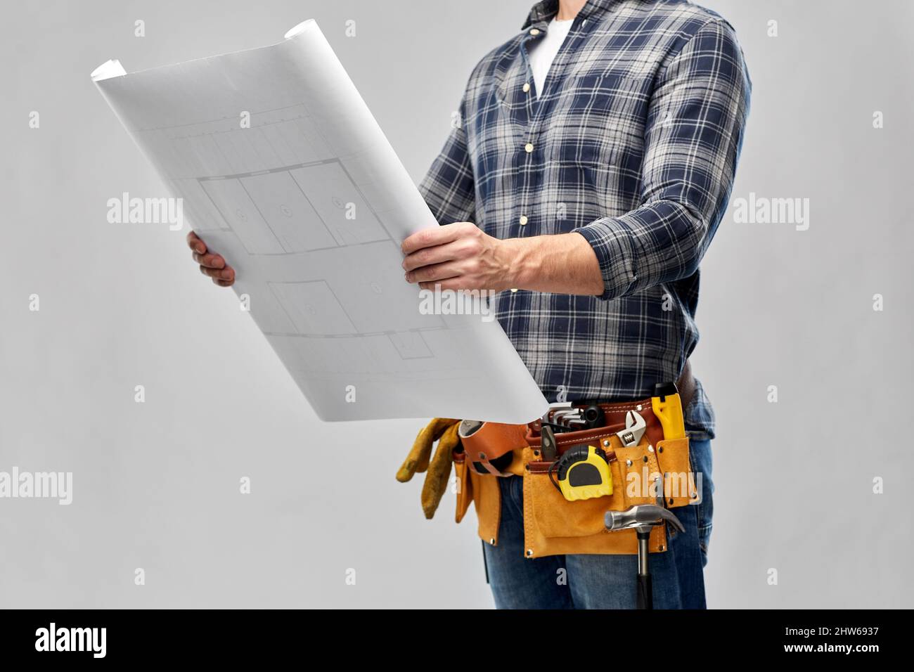male builder with blueprint and working tools Stock Photo - Alamy