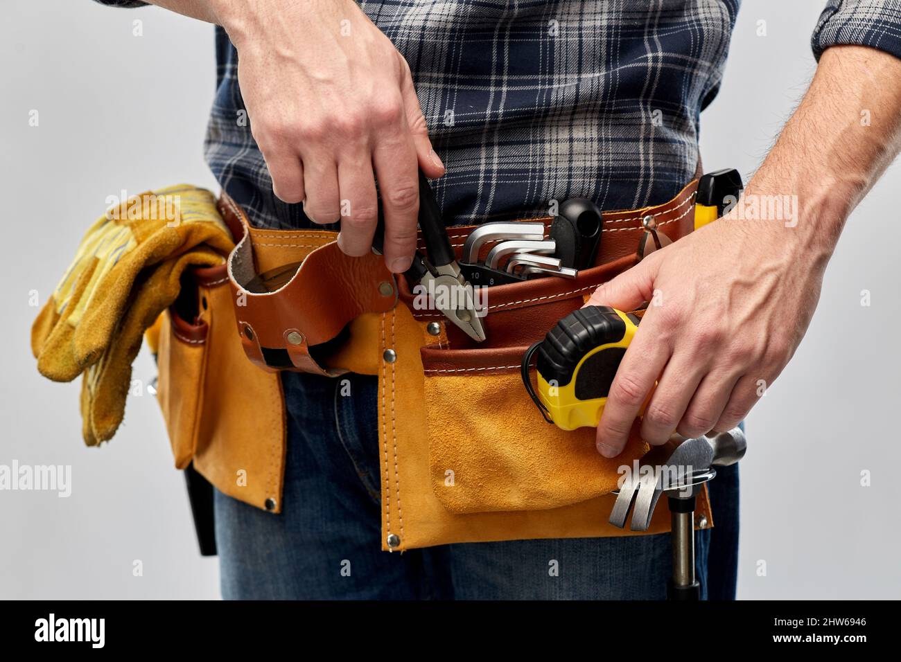 male worker or builder with working tools on belt Stock Photo - Alamy