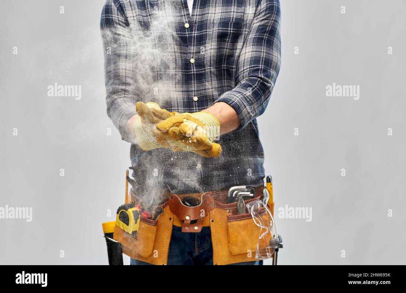 builder with working tools and gloves using talc Stock Photo - Alamy