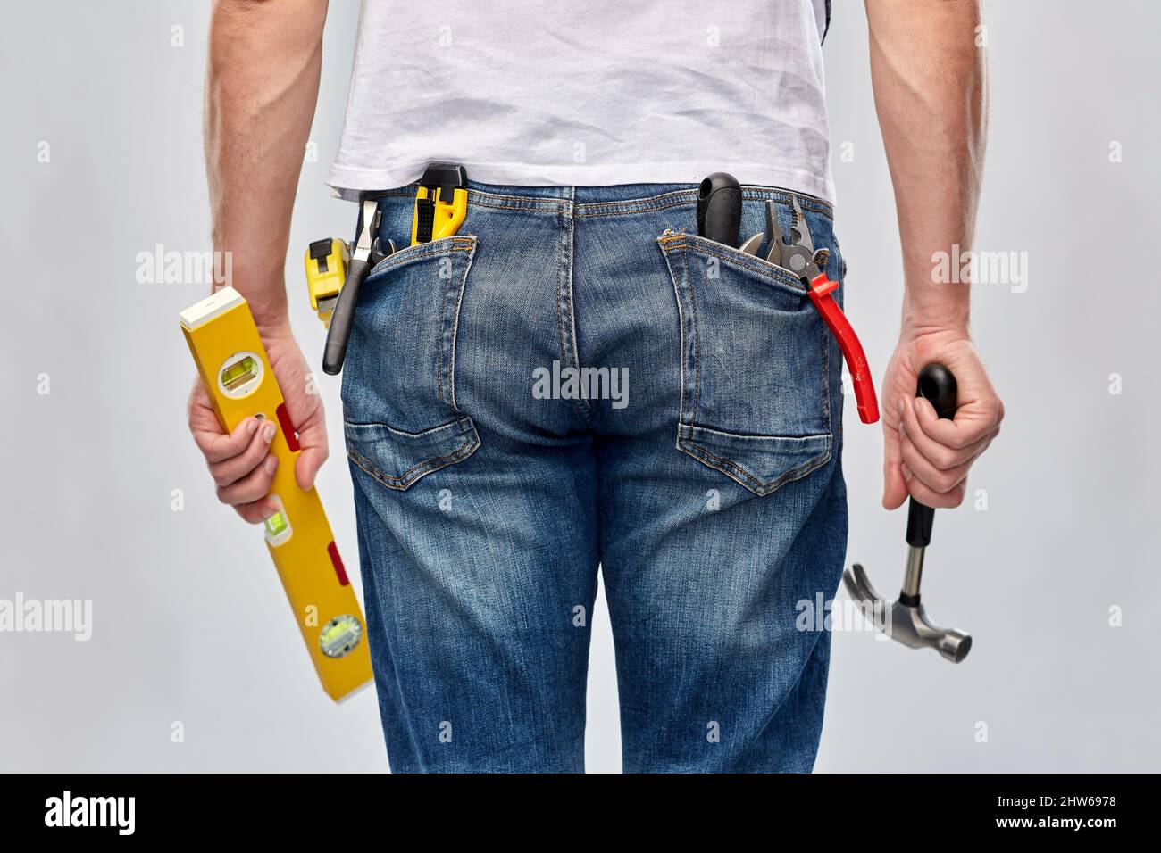 man with level and working tools in pockets Stock Photo - Alamy