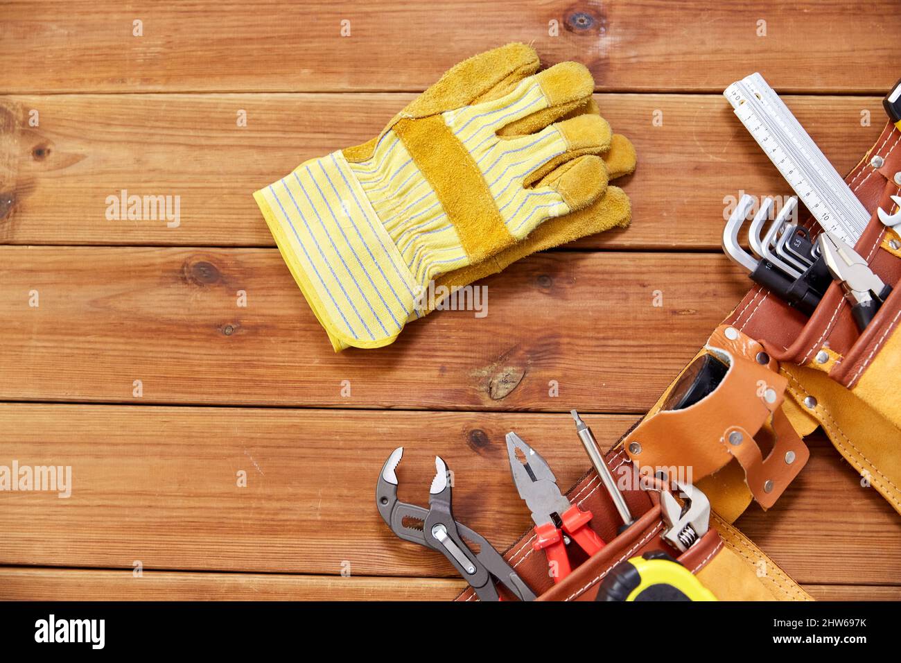 different work tools in belt on wooden boards Stock Photo - Alamy
