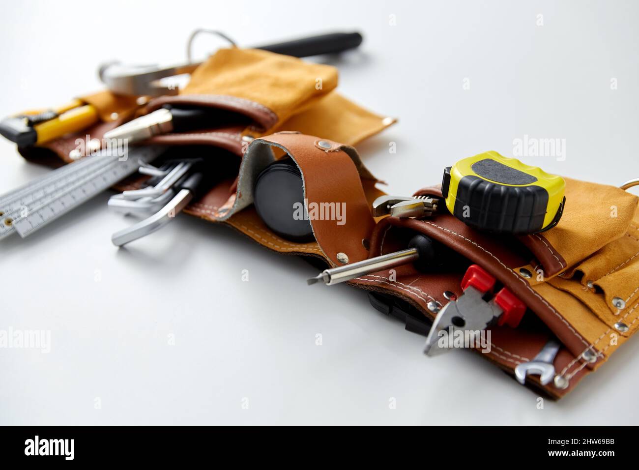 different work tools in belt on white background Stock Photo - Alamy