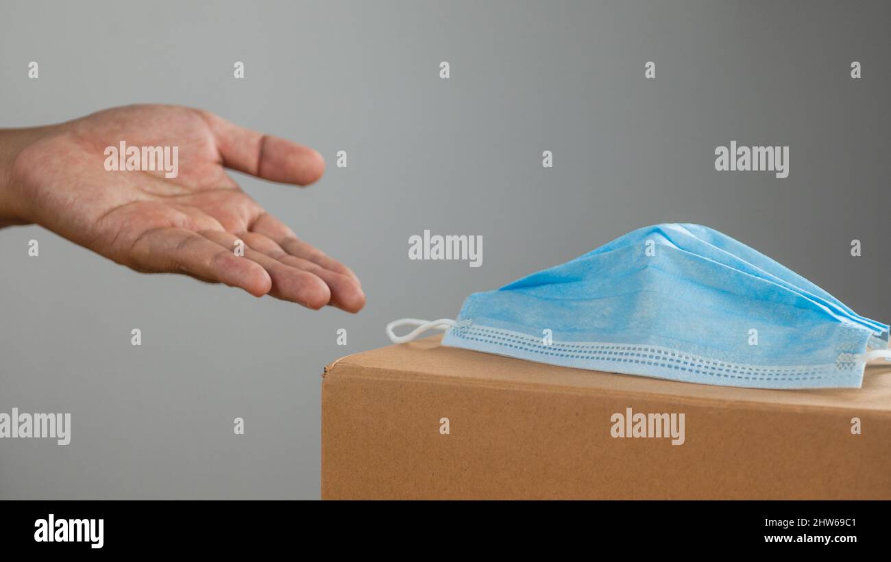 Medical concept. Giving a blue mask to someone for disease protection ...