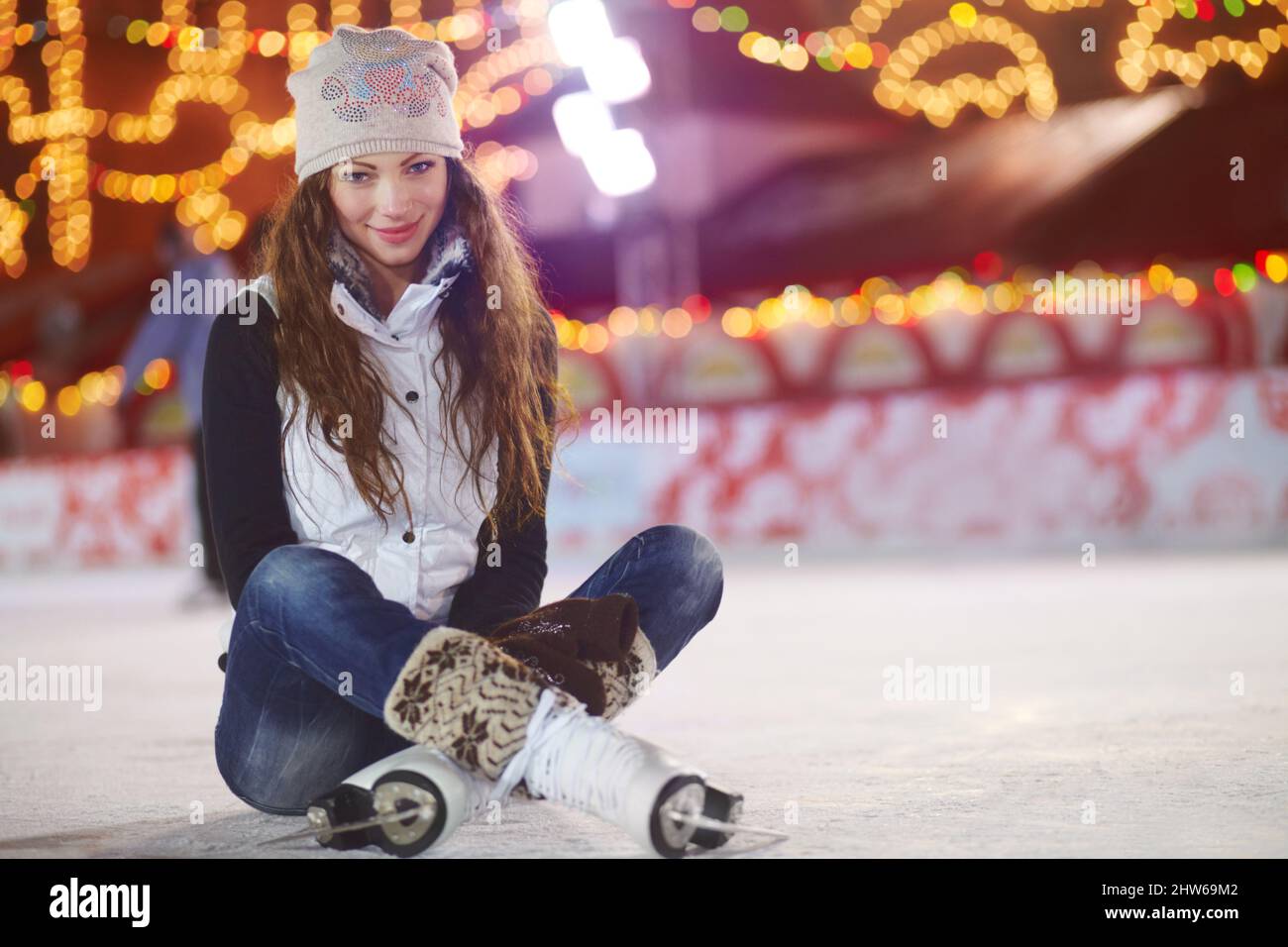 Ready to cut up some ice. Shot of a woman sitting on sitting on an ice ...