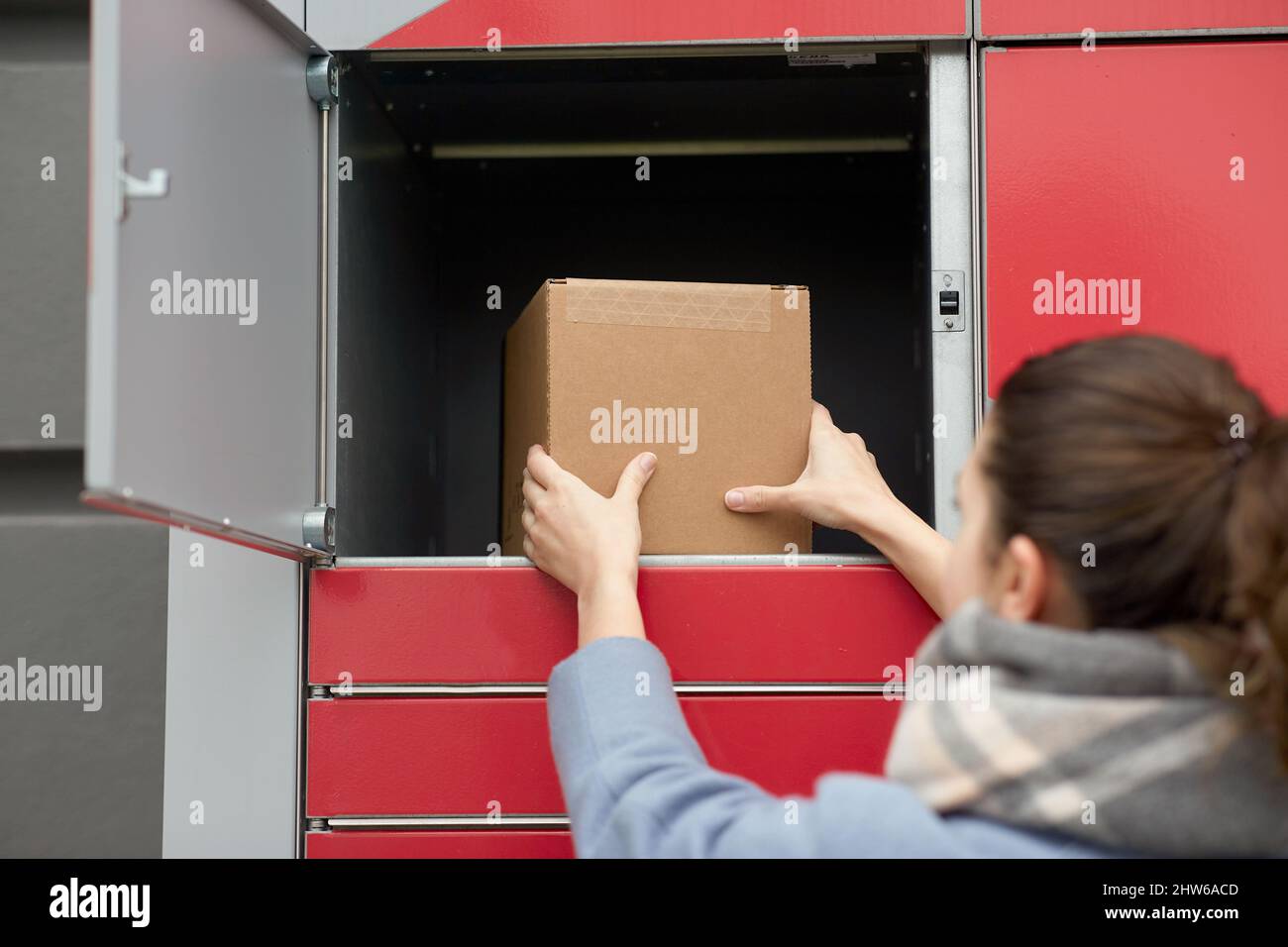 Woman putting box automated hi-res stock photography and images - Alamy