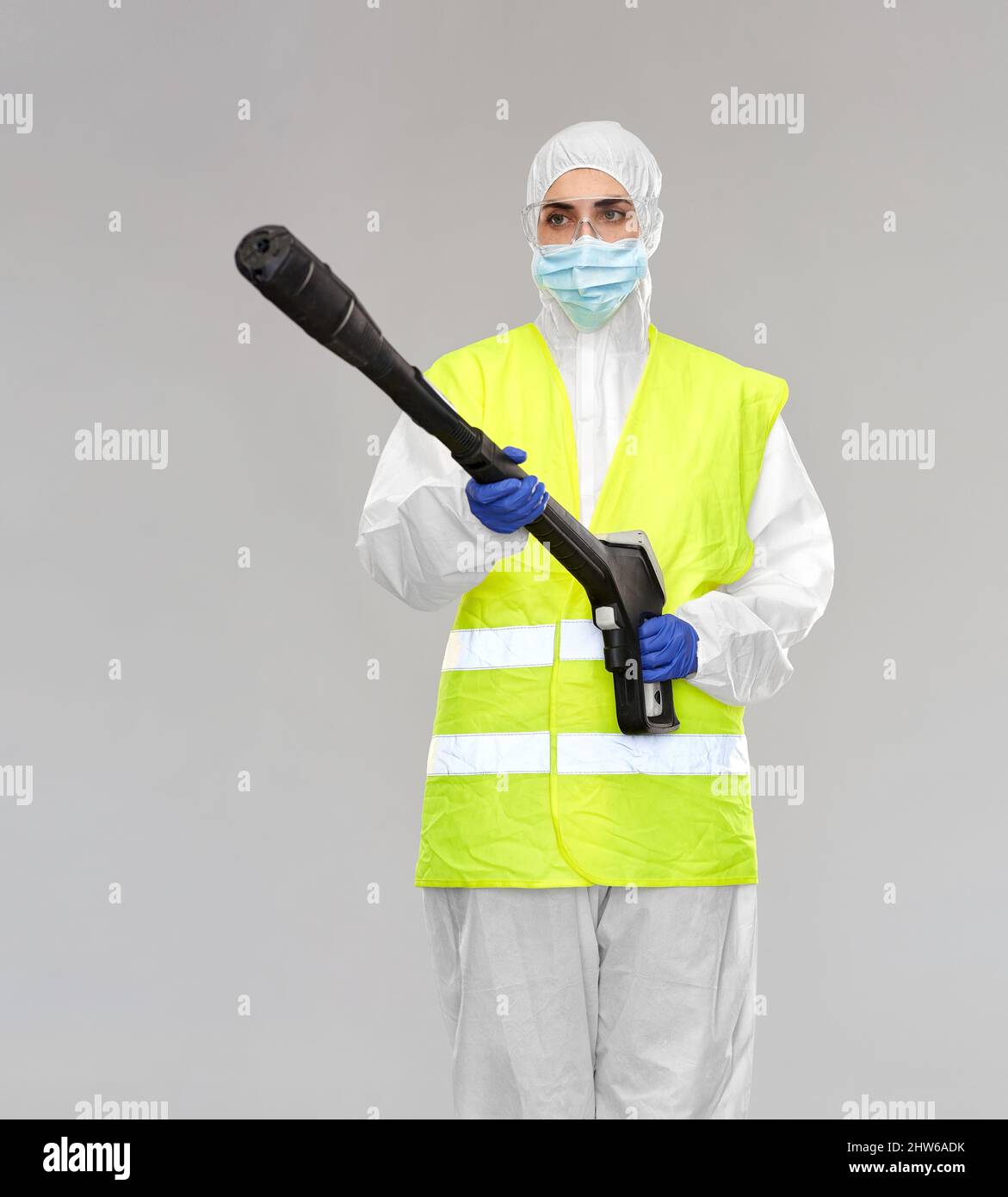 sanitation worker in hazmat with pressure washer Stock Photo - Alamy