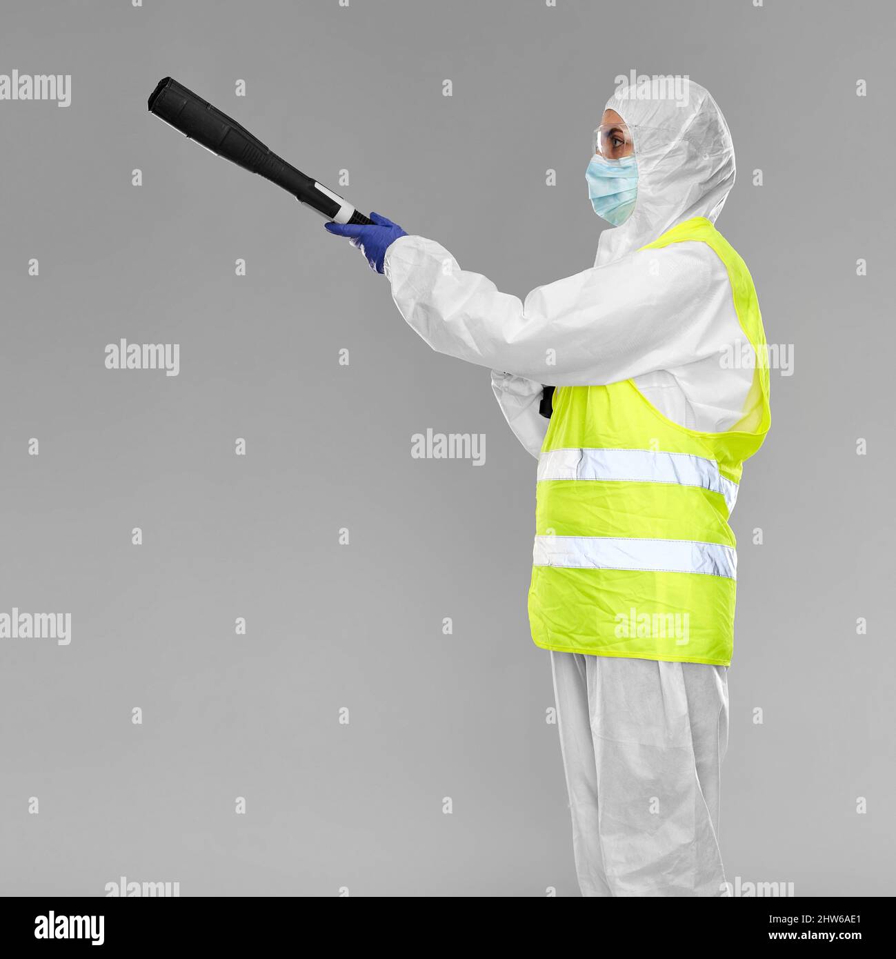 sanitation worker in hazmat with pressure washer Stock Photo - Alamy