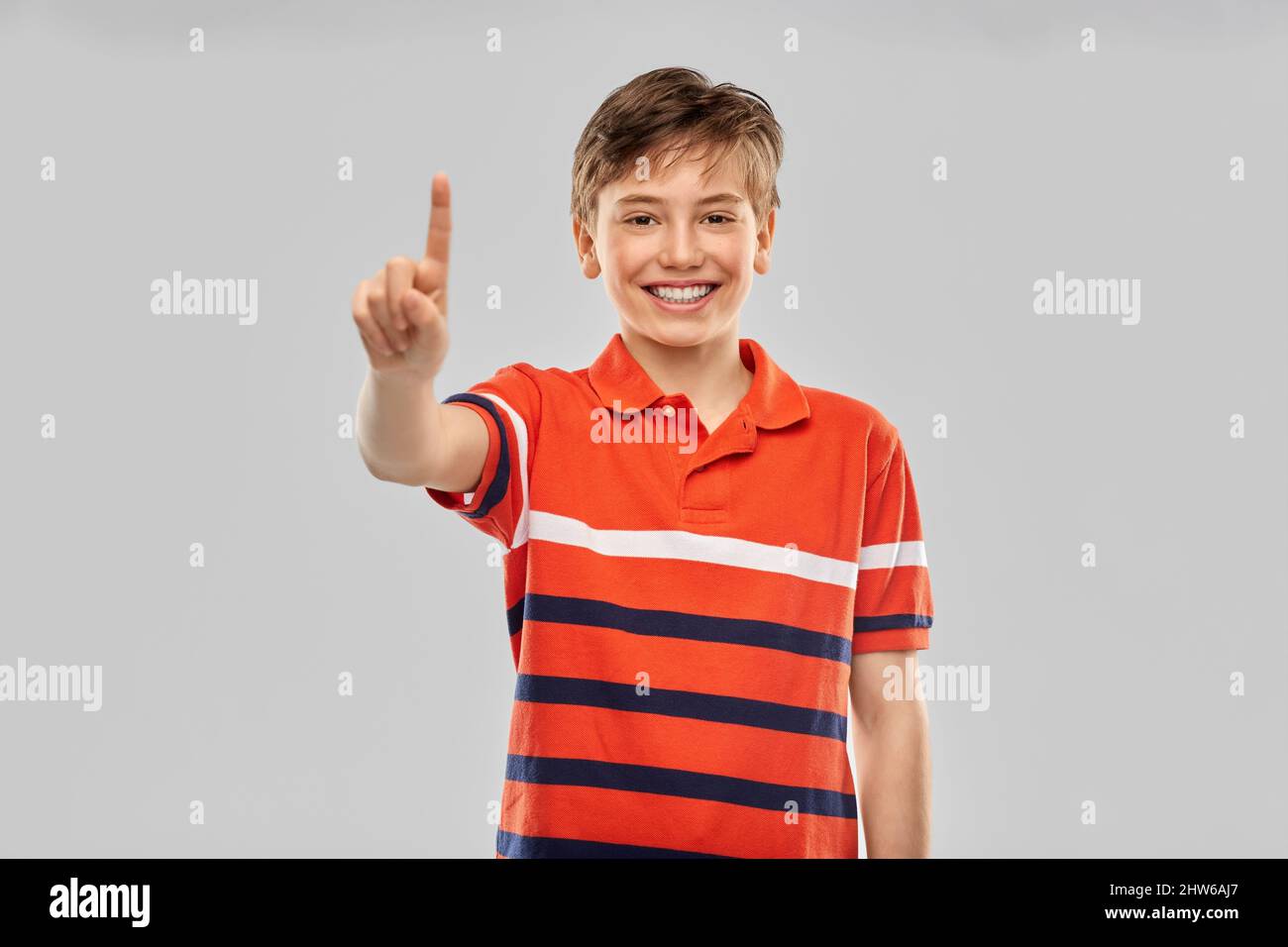 portrait of happy smiling boy showing one finger Stock Photo - Alamy