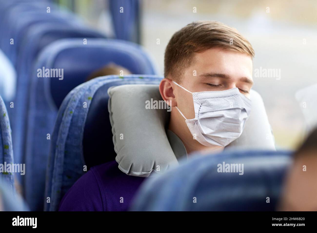 man in mask sleeping in travel bus with pillow Stock Photo - Alamy