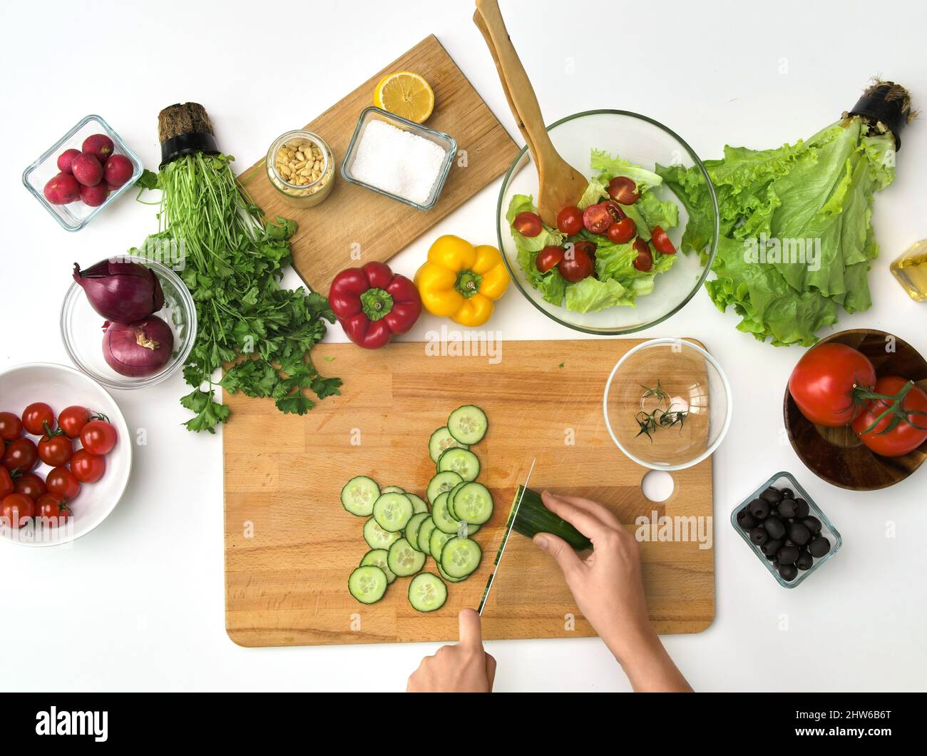 hands chopping cucumber on cutting board Stock Photo - Alamy