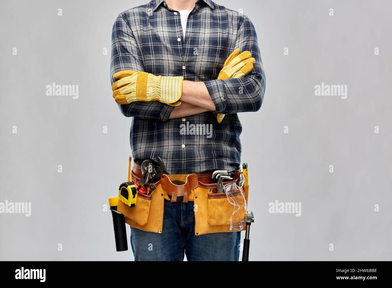 builder with working tools, goggles and gloves on Stock Photo - Alamy