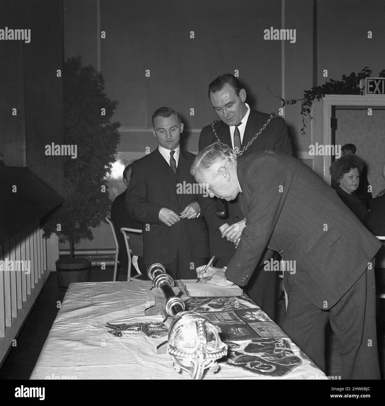 Prime Minister Harold Wilson (1916 - 1995) signing the visitors book at ...