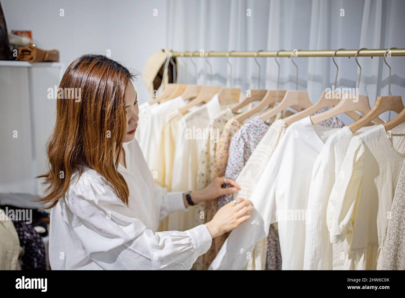 portrait of happy female asian entrepreneur working in her modern store ...