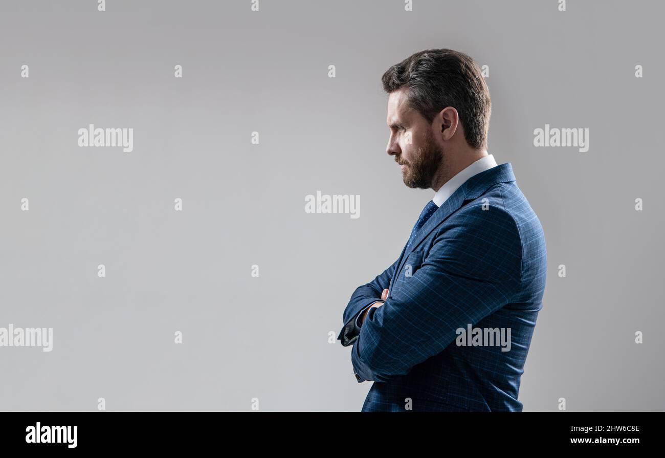 Hes a serious man. Serious businessman sideway grey background ...