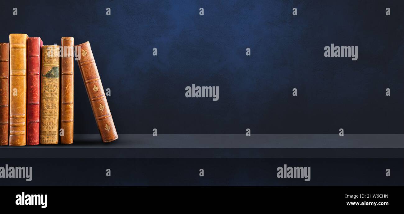 Row of old books on black shelf. Horizontal background banner Stock ...