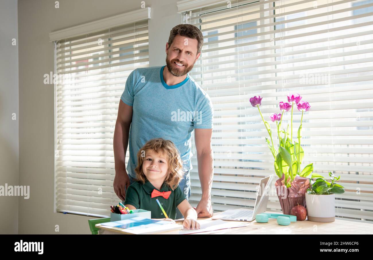 happy bearded daddy writing school homework with his child son in ...