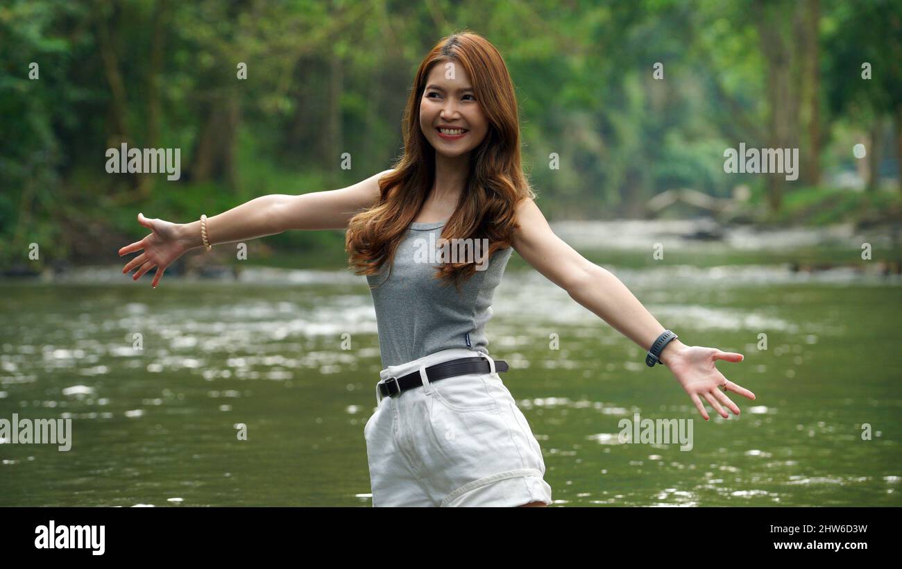 Happy young Southeast Asian female near a lake Stock Photo - Alamy