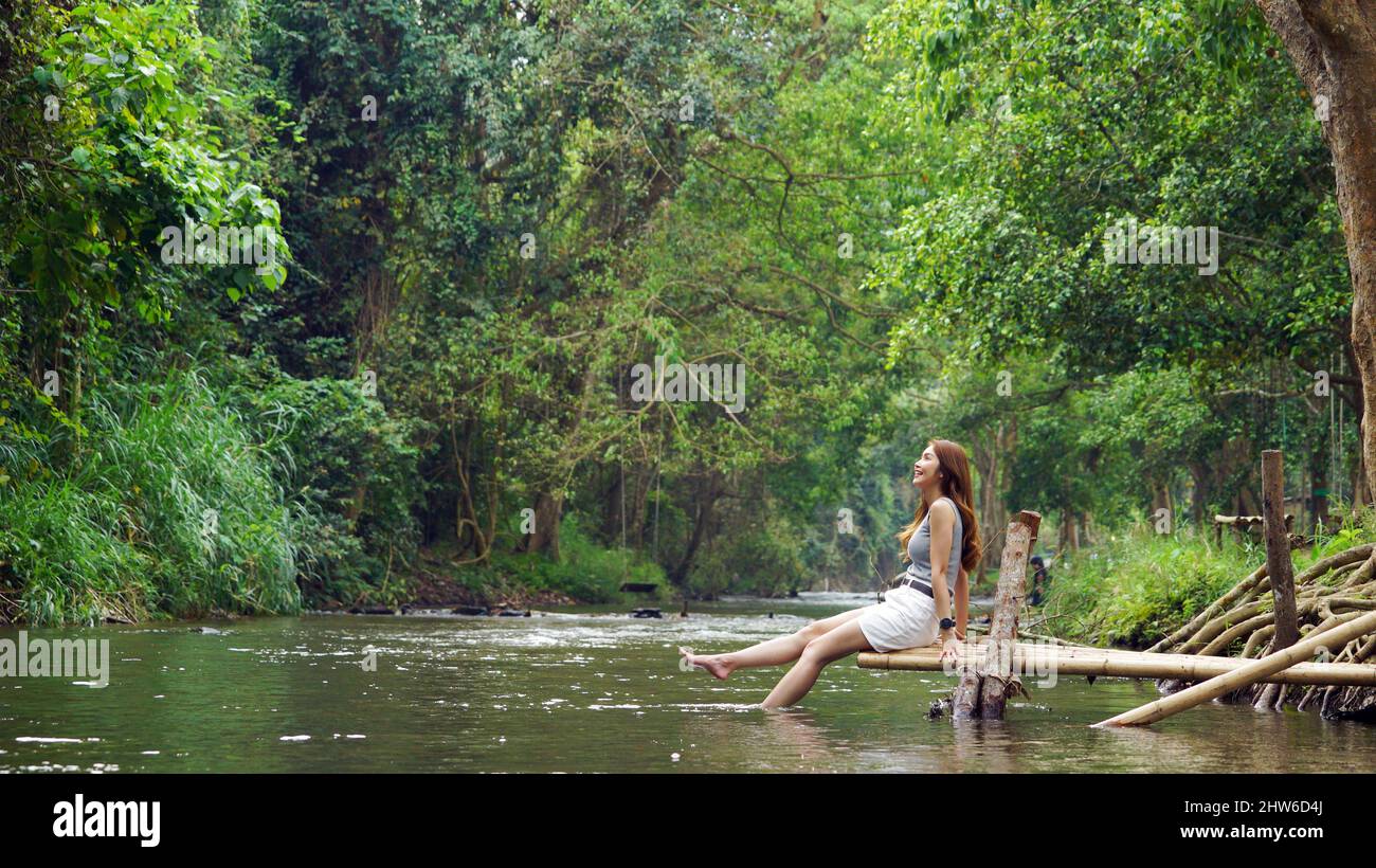 Happy young Southeast Asian female near a lake Stock Photo - Alamy