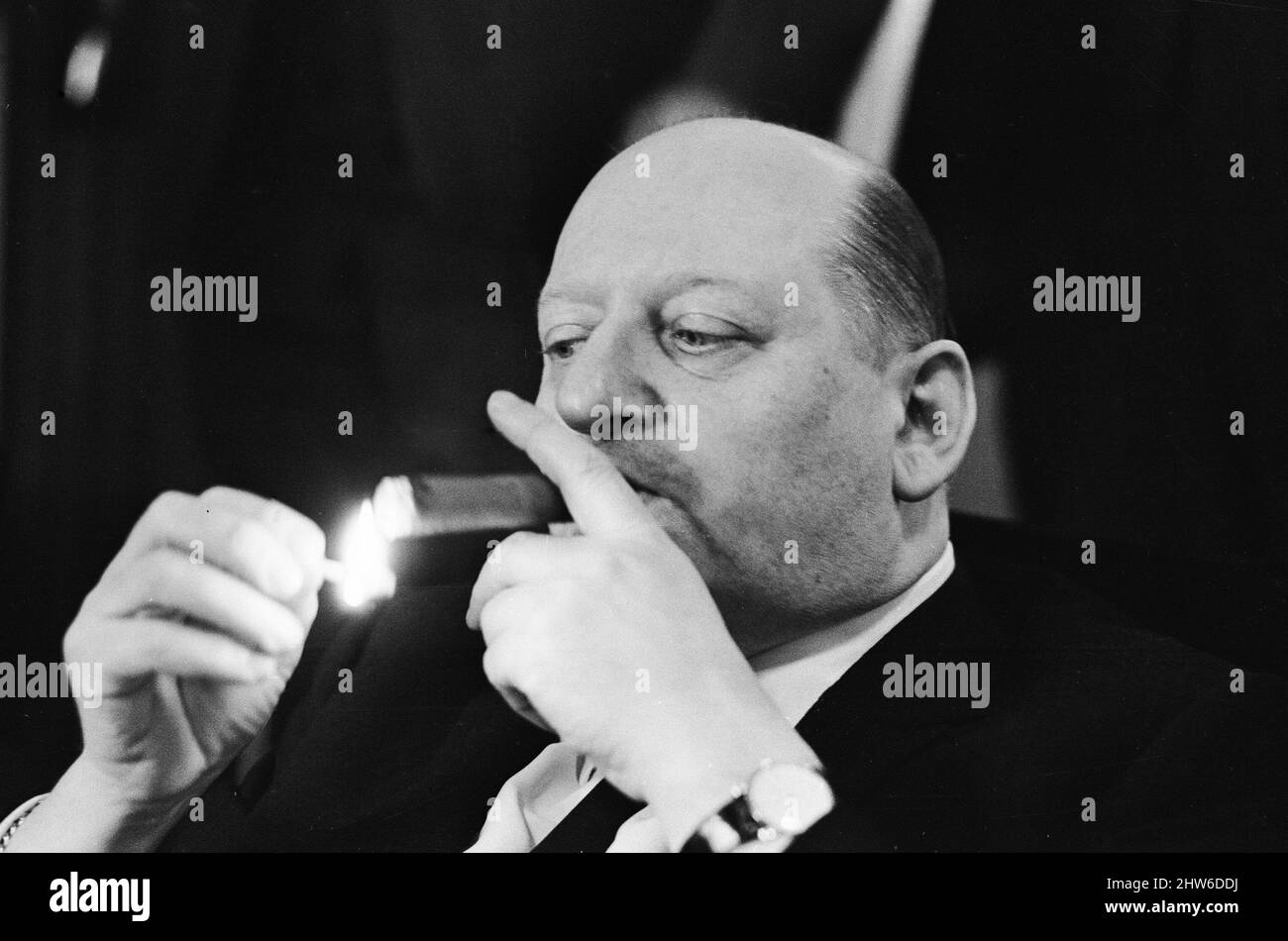 Media Mogul Lord Lew Grade lighting his cigar with a match. 24th ...