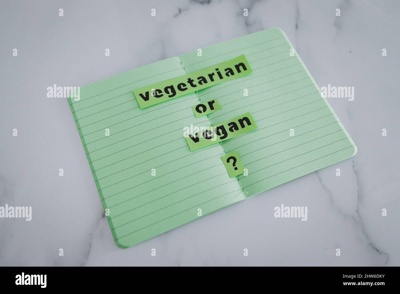 vegetarian or vegan text on top of green notebook, concept of healthy ...