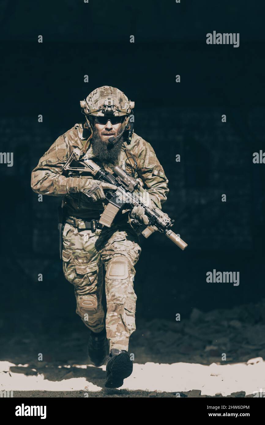 A bearded soldier in uniform of special forces in a dangerous military ...