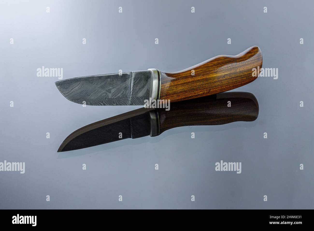 Raven knife on a mirror surface, handmade, damask steel blade, wenge ...