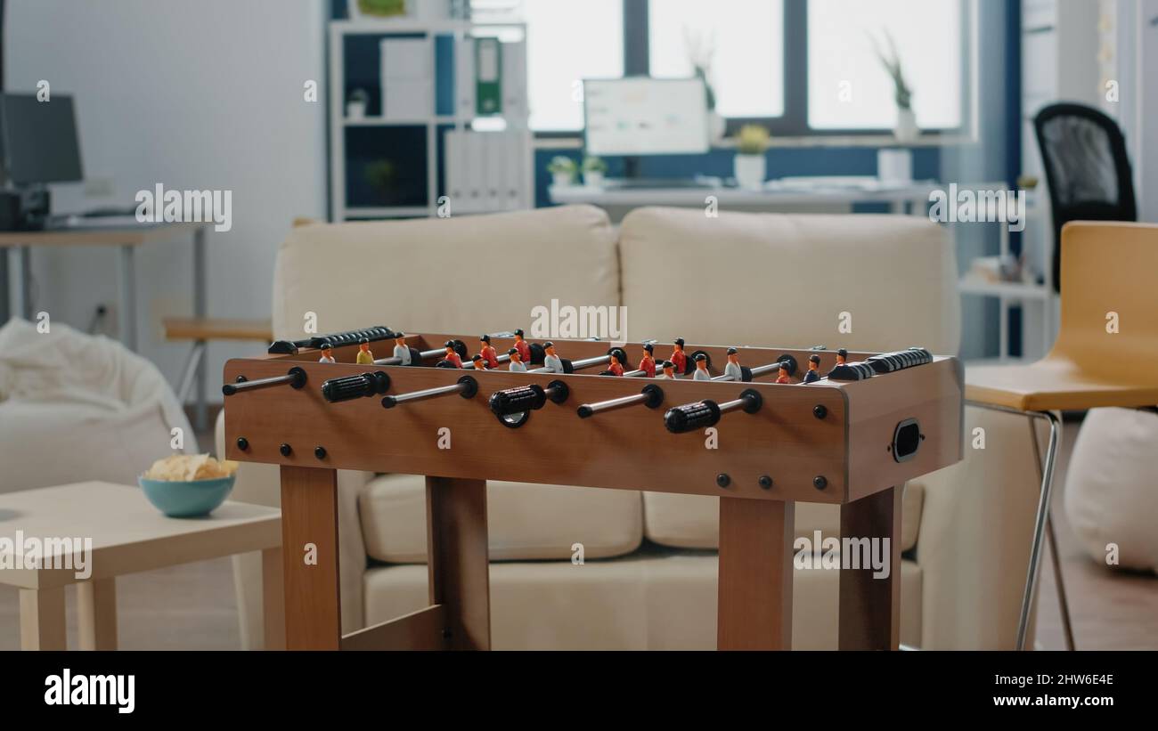 Nobody in workplace with foosball table to play soccer game and chips ...