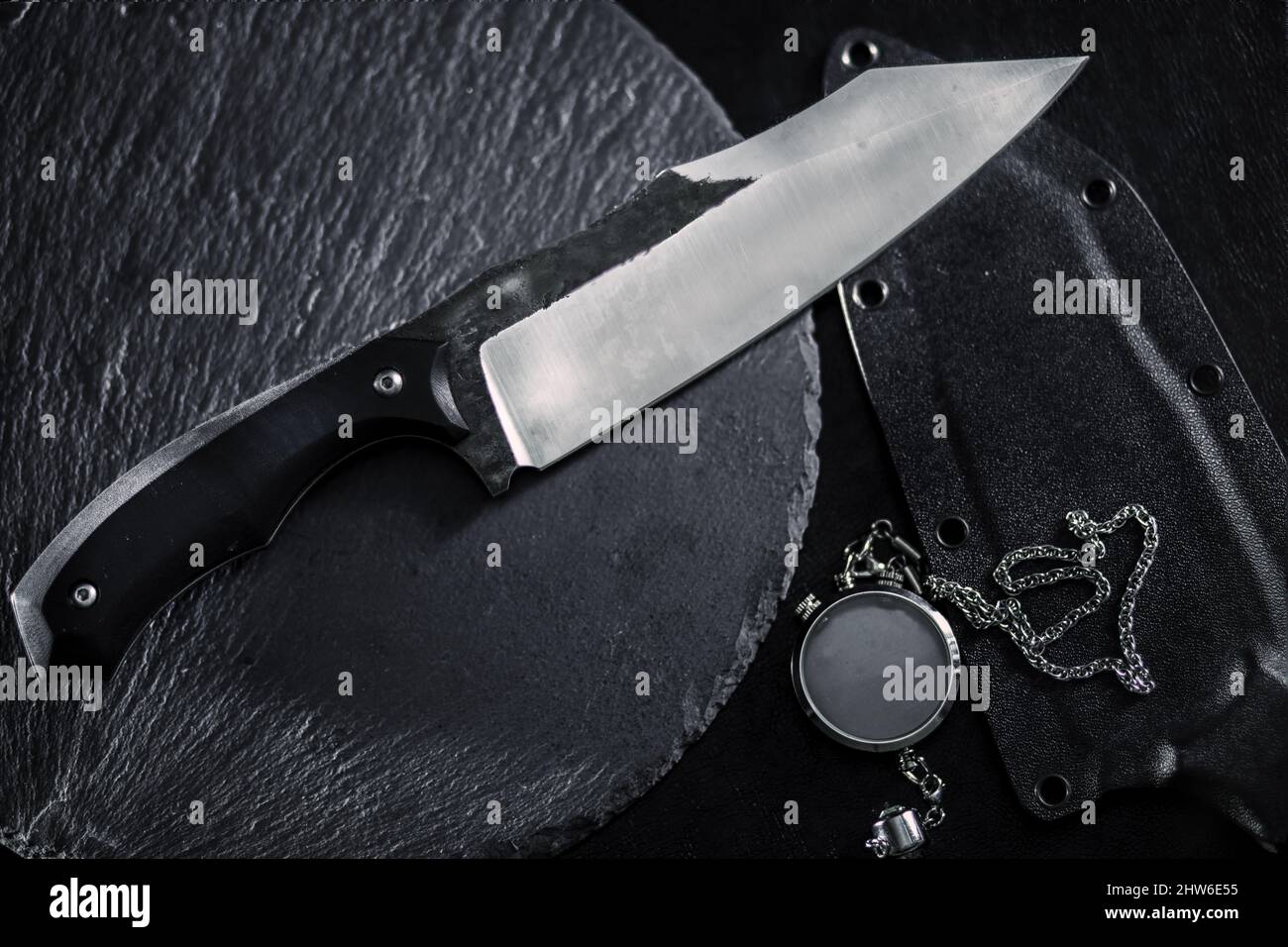 All-metal, tactical, kitchen knife on a mirror surface, handwork, steel ...