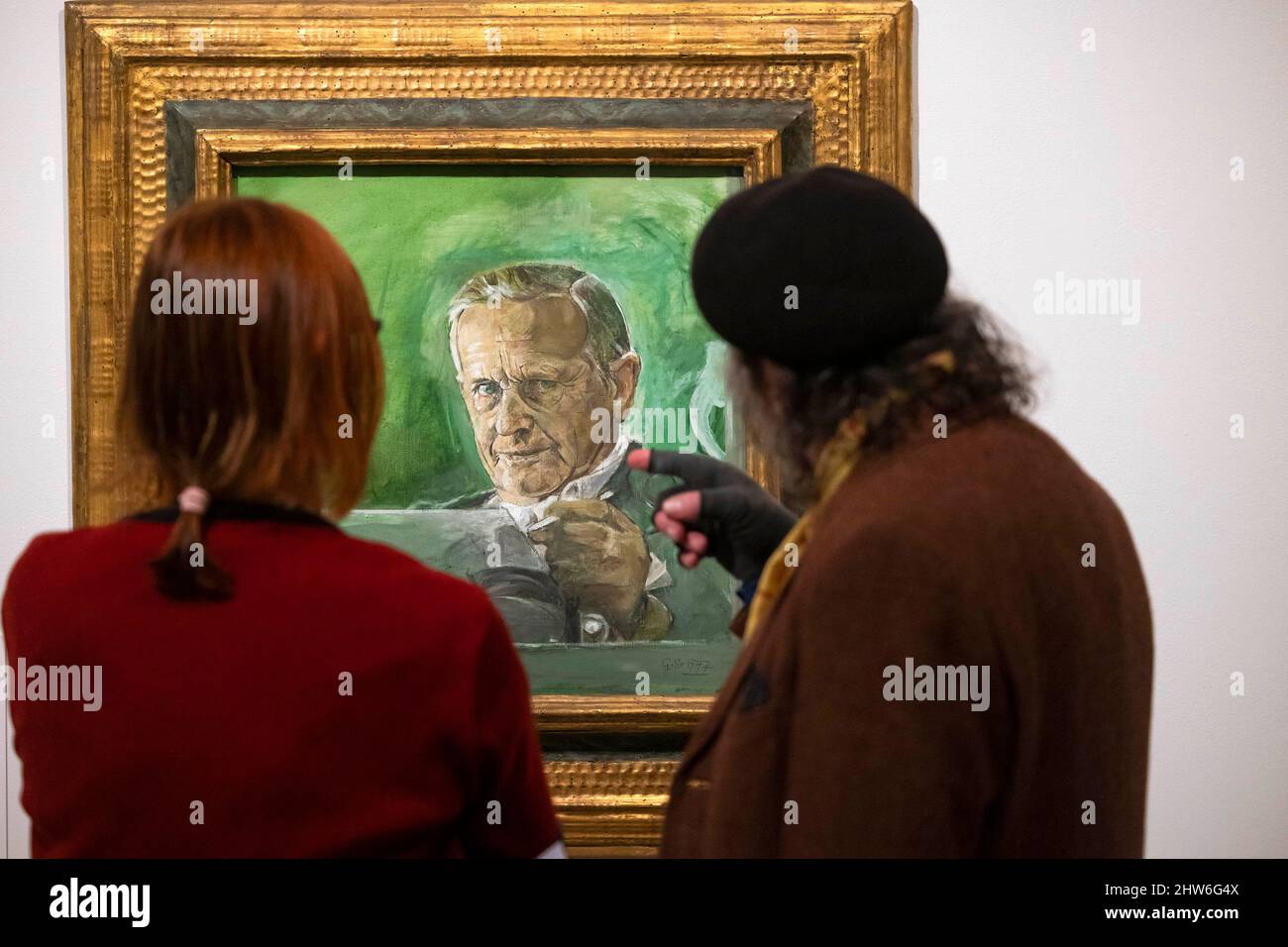 EDITORIAL USE ONLY Members of the public look at a self-portrait of ...