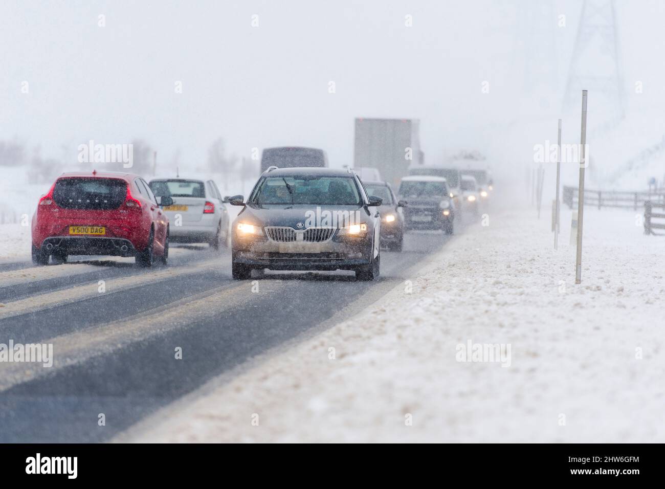 Cars drive through a blizzard on the A9 as parts of Scotland are under ...