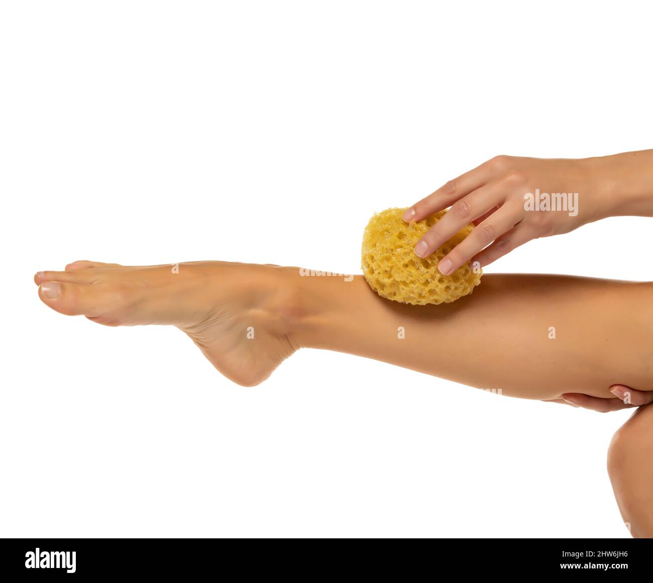 Woman pampring her leg with sponge on a white background Stock Photo ...