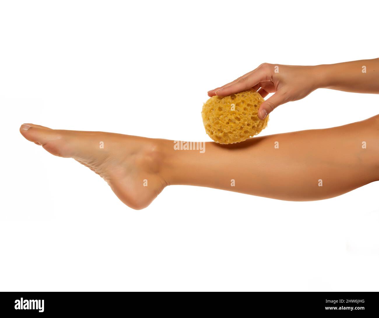 Woman pampring her foot with sponge on a white background Stock Photo ...