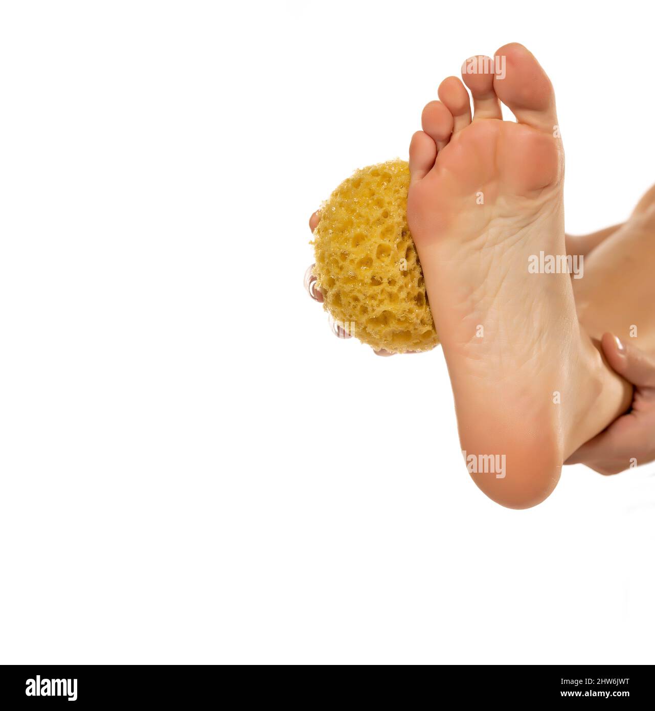 Woman pampring her foot with a sponge on a white background Stock Photo ...