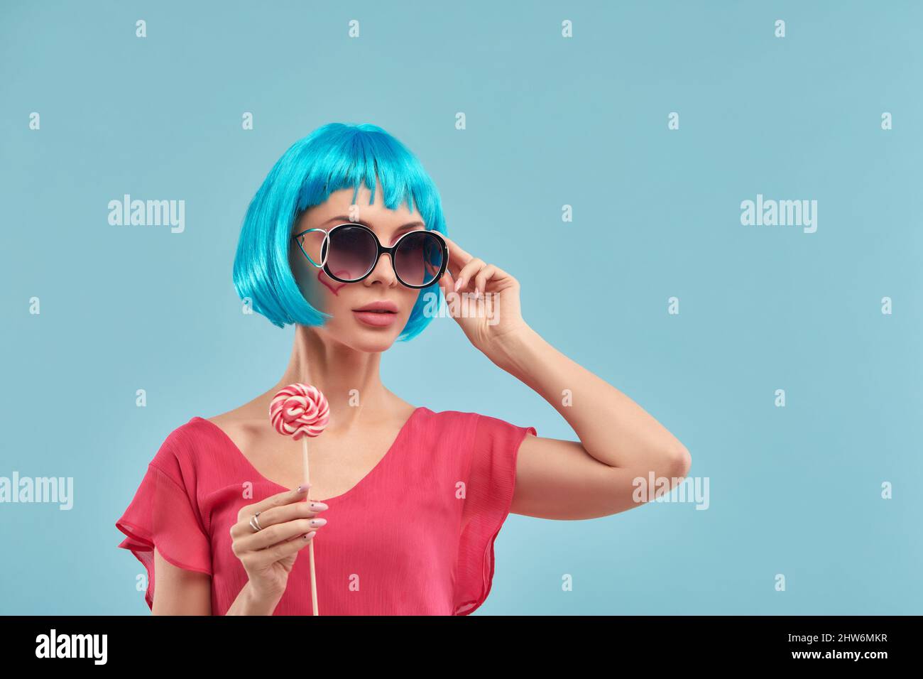 Candy Lolli pop Party Girl posing in white studio. Role-playing games, halloween concept, sweet ...
