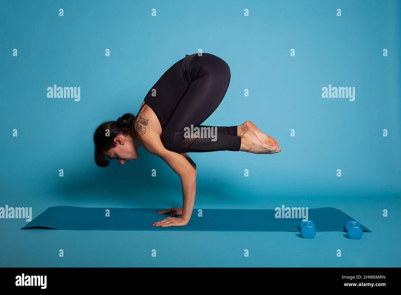 Pilates person standing in hands on yoga mat stretching exercises ...