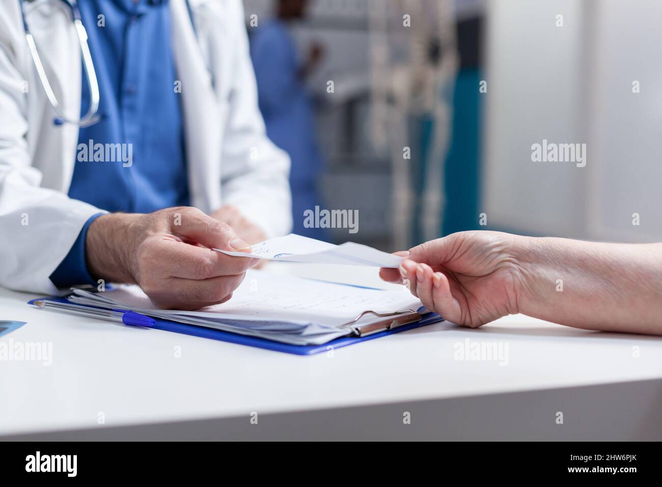 Handing papers hospital hi-res stock photography and images - Alamy
